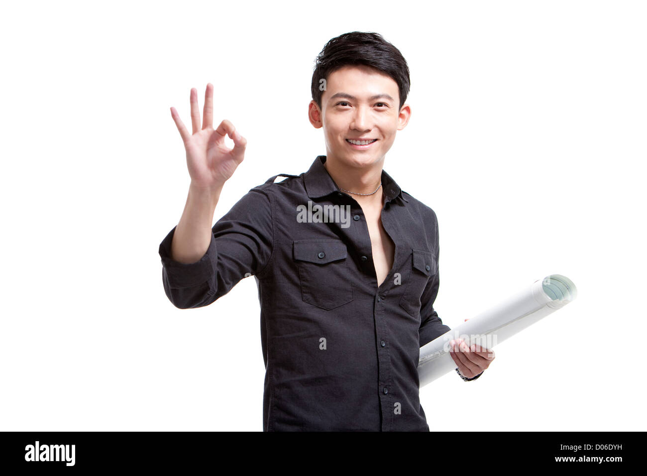 Young man with blueprint doing OK sign Stock Photo - Alamy
