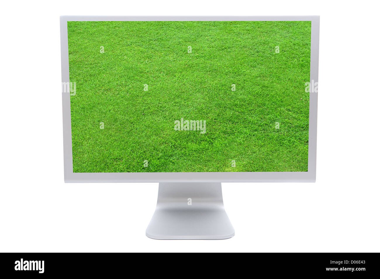 Computer monitor with the image of a green grass solated on white ...