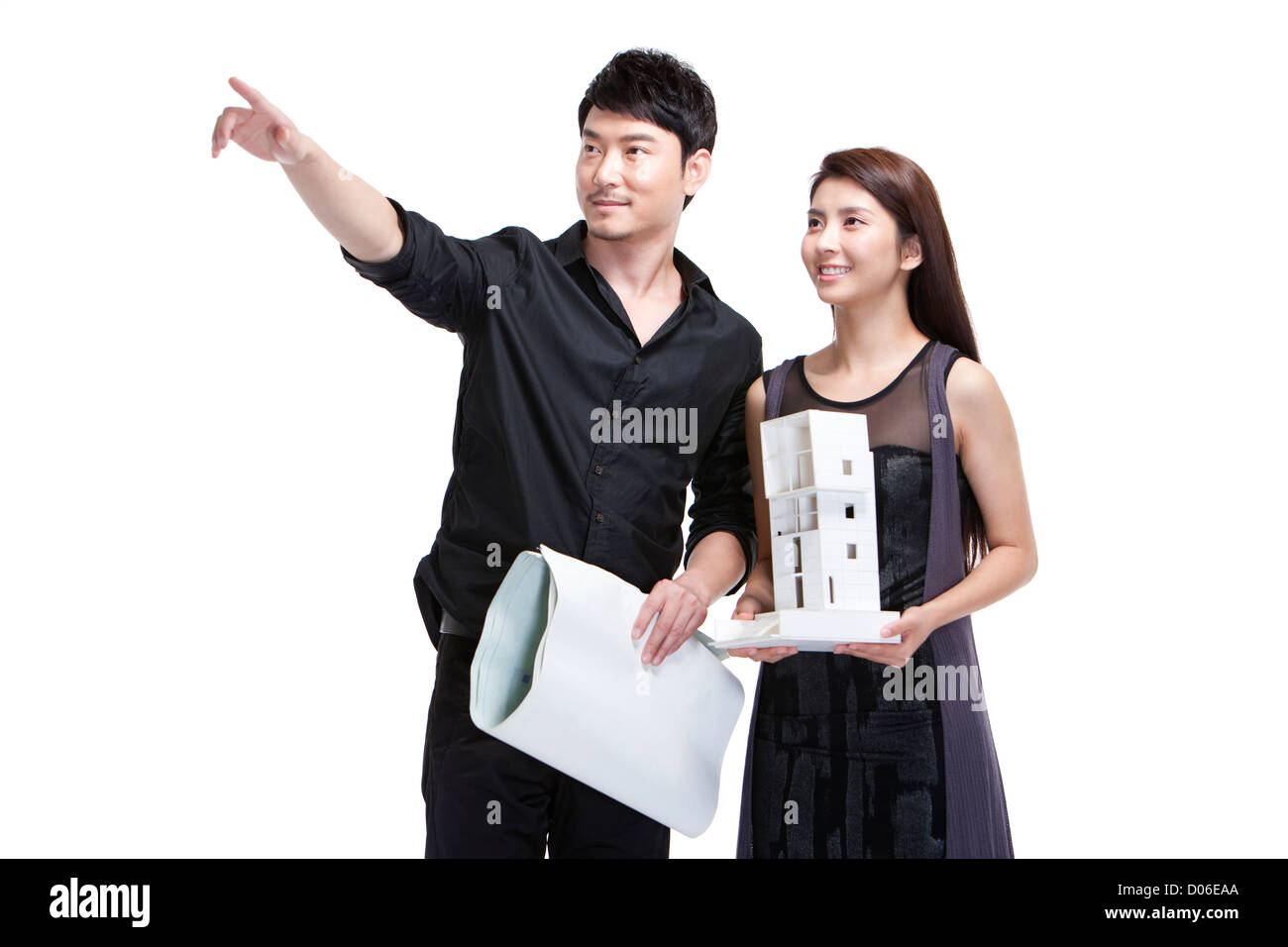 Architects with Architectural model and blueprint pointing Stock Photo ...