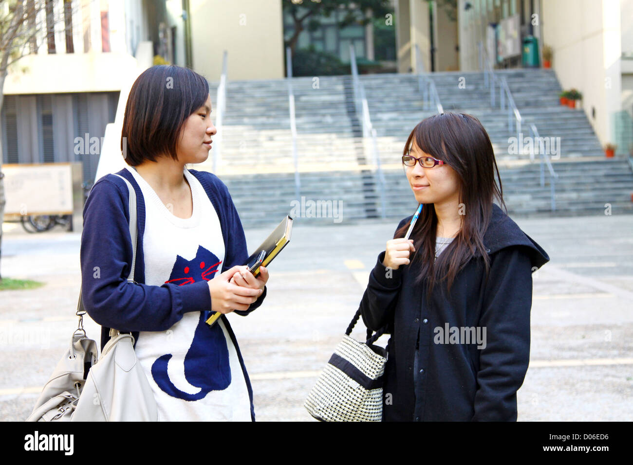 Asian students studying and discussing in university Stock Photo - Alamy