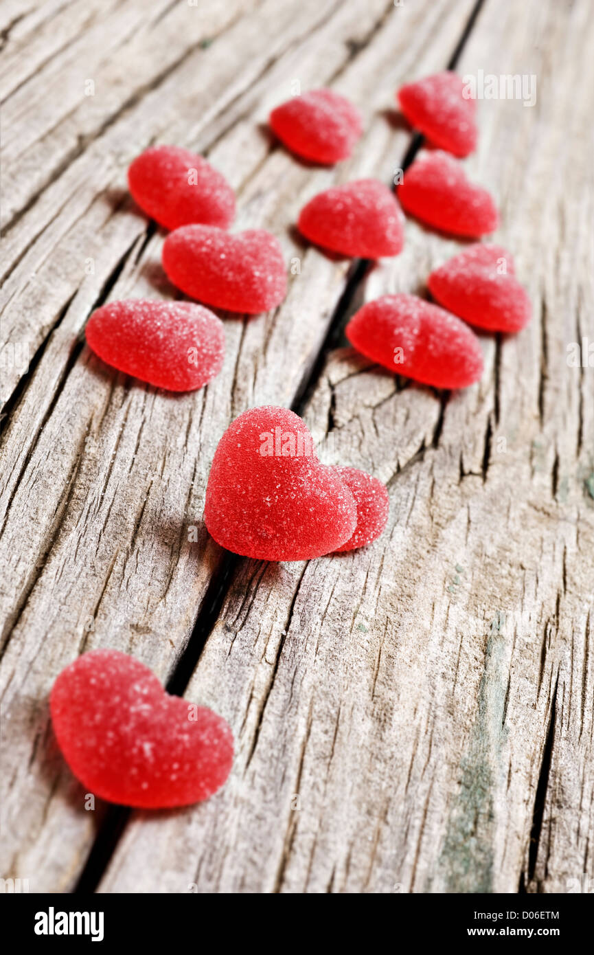 Red heart shaped jelly sweets on a rustic background Stock Photo - Alamy