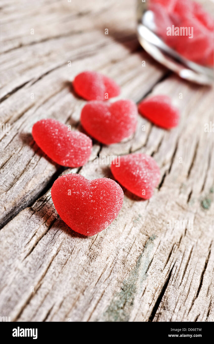 Red heart shaped jelly sweets on a rustic background Stock Photo - Alamy