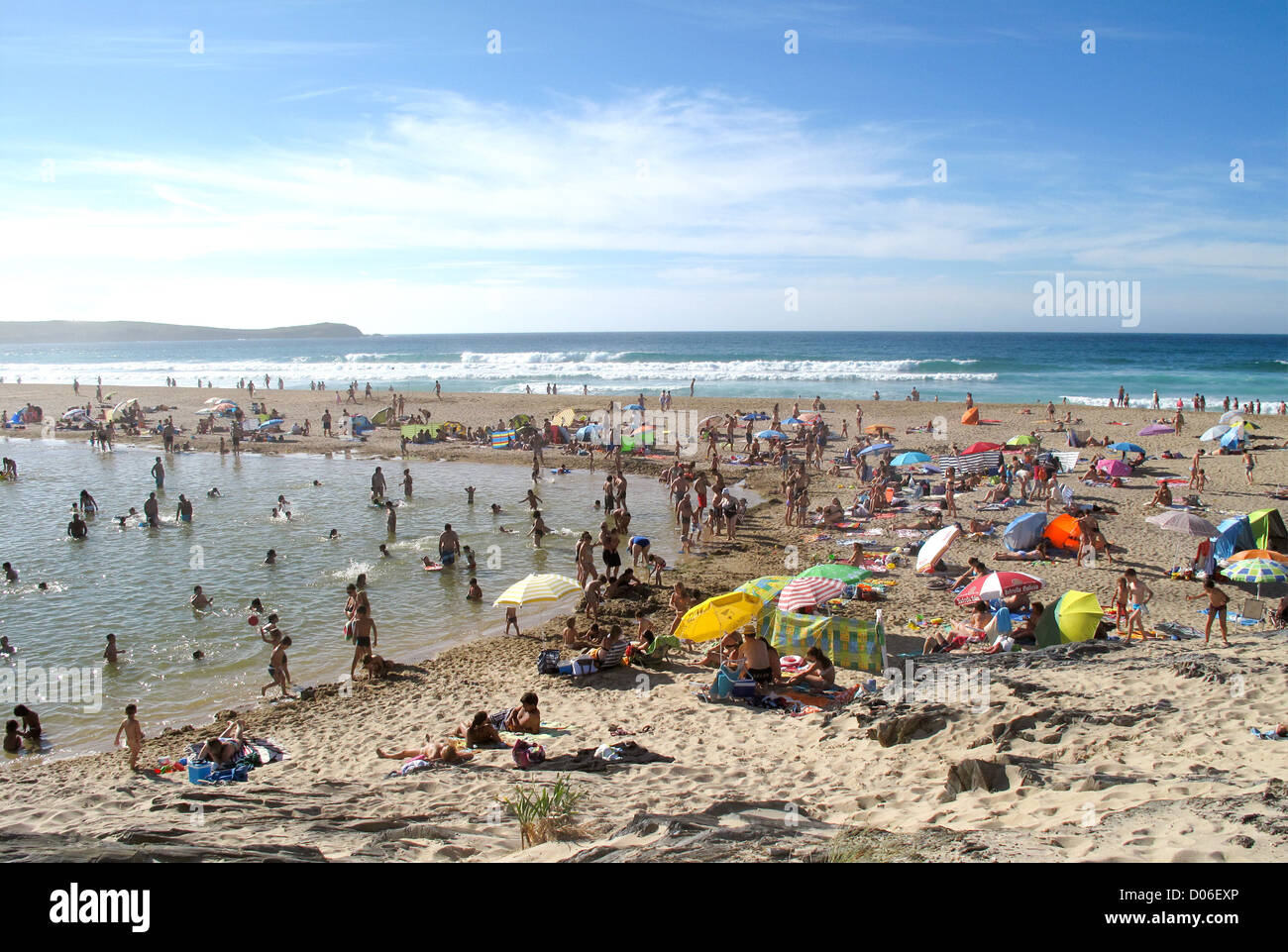 Beach full of tourists with many umbrellas Stock Photo - Alamy