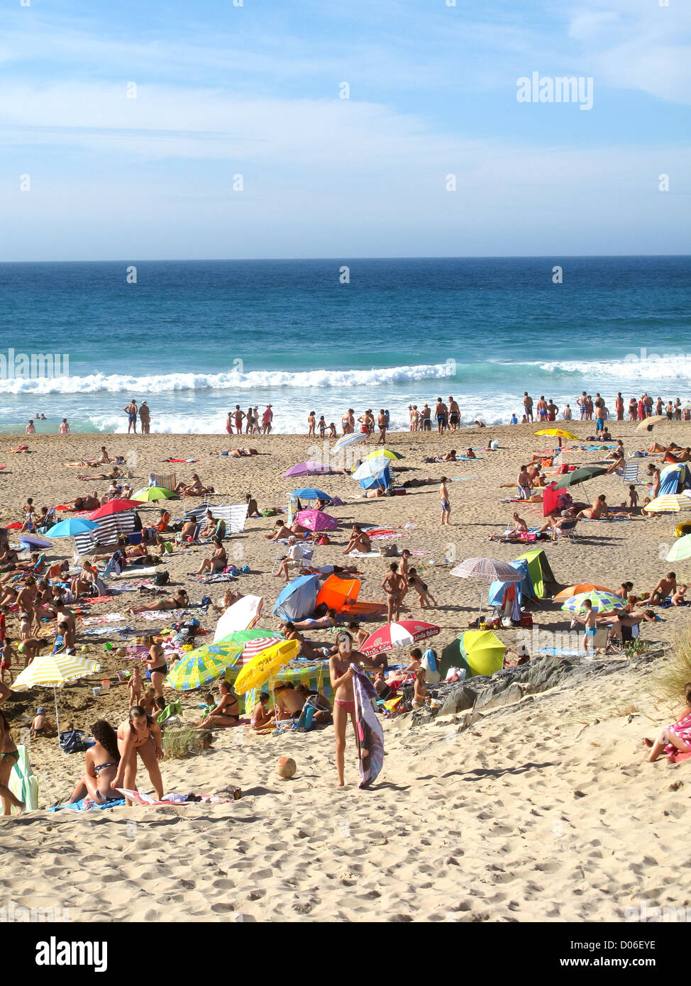 Beach full of tourists with many umbrellas Stock Photo - Alamy