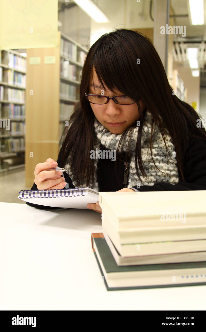 Asian woman studying hard in a university Stock Photo - Alamy