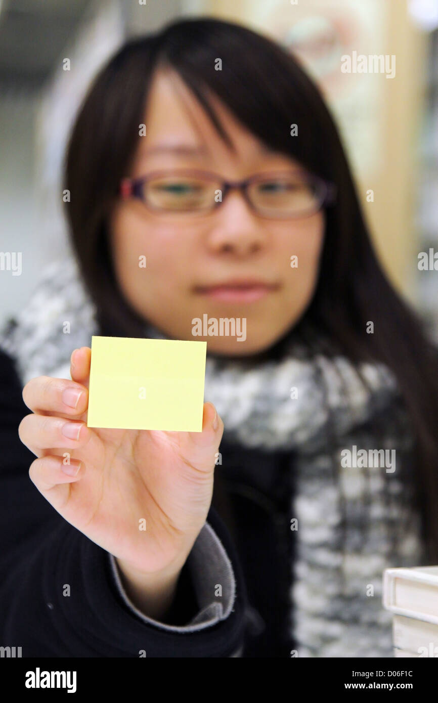 Asian student with yellow memo paper Stock Photo - Alamy