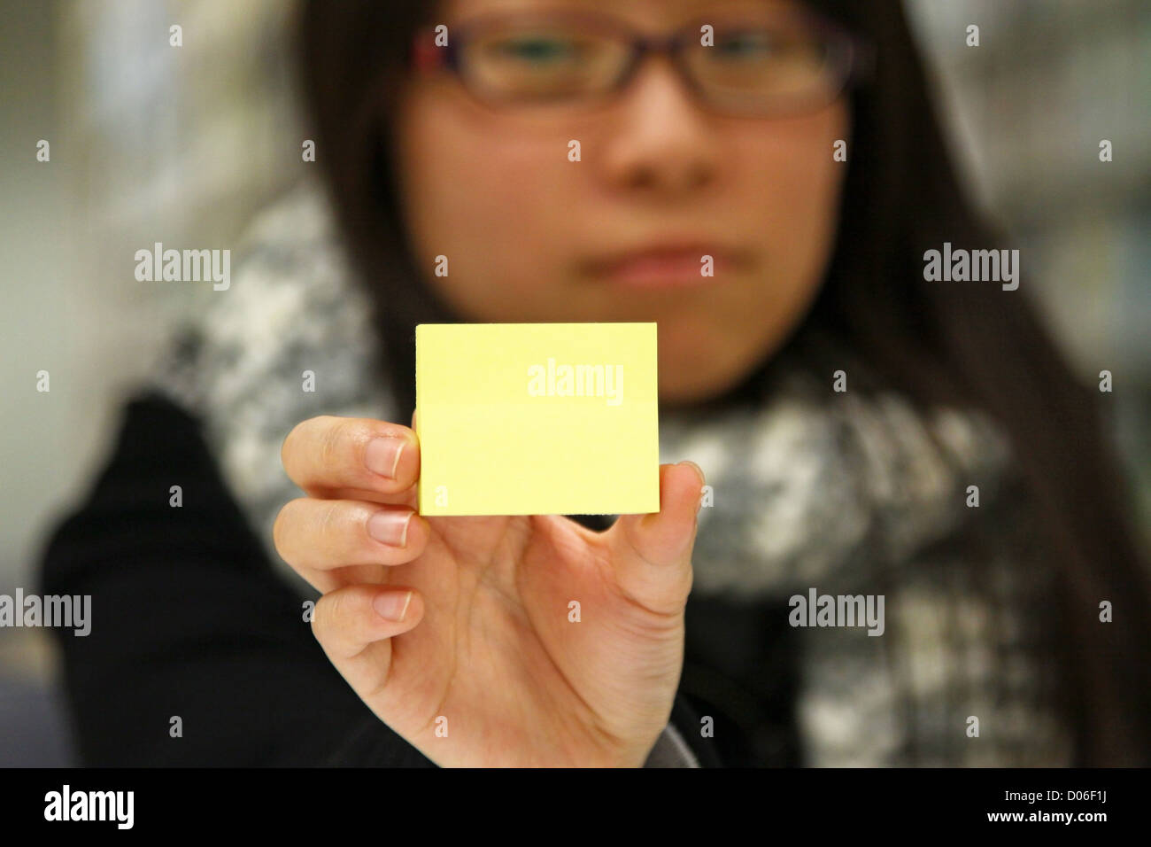 Asian student with yellow memo paper Stock Photo - Alamy
