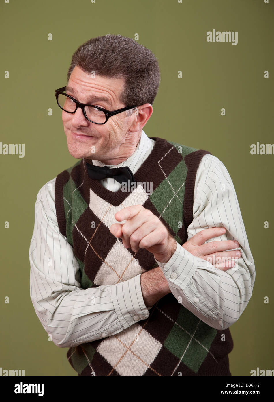 Young Caucasian nerd pointing index finger on green background Stock ...