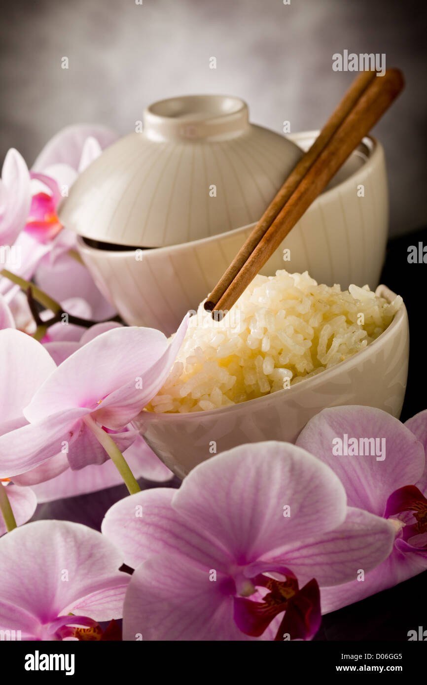photo of delicious asian rice dish with orchid flowers around Stock ...