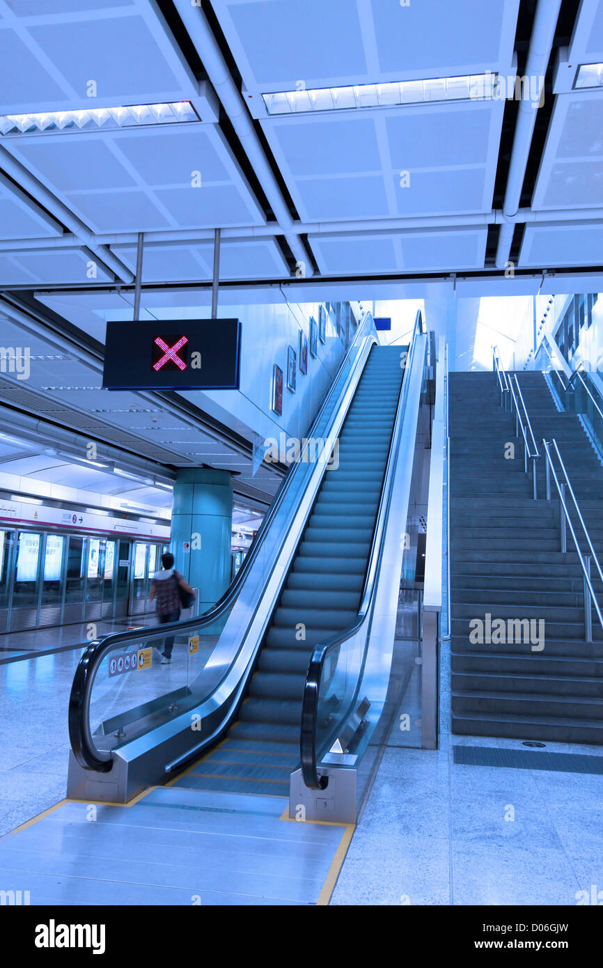 Moving escalator in train station Stock Photo - Alamy