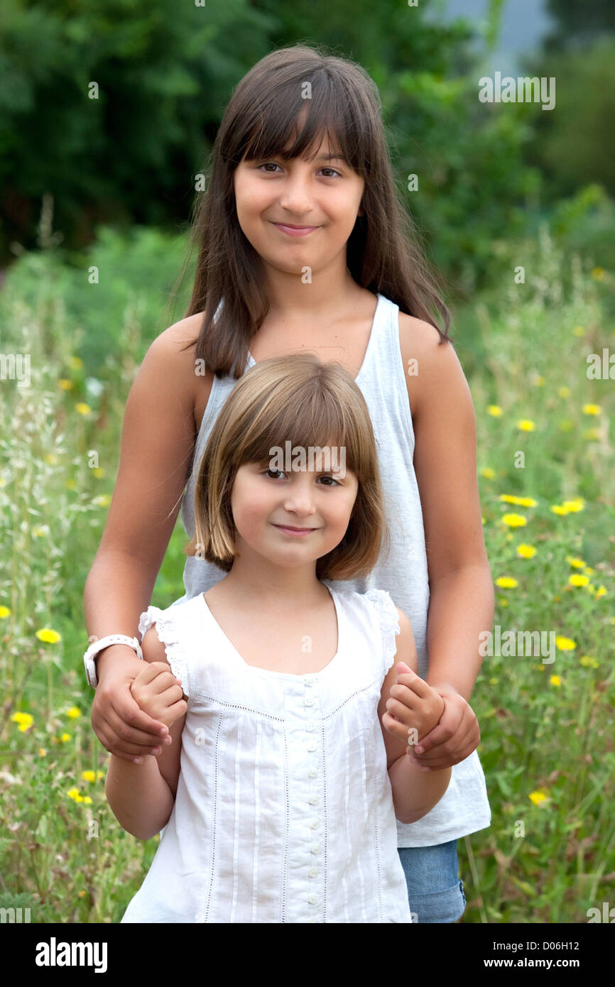 Two beautiful smiling sisters on the outside Stock Photo - Alamy