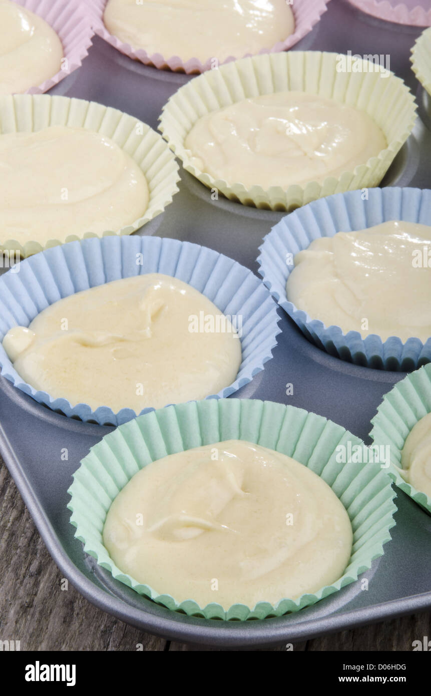 vanilla cake batter in a cupcake baking tin before baking Stock Photo ...