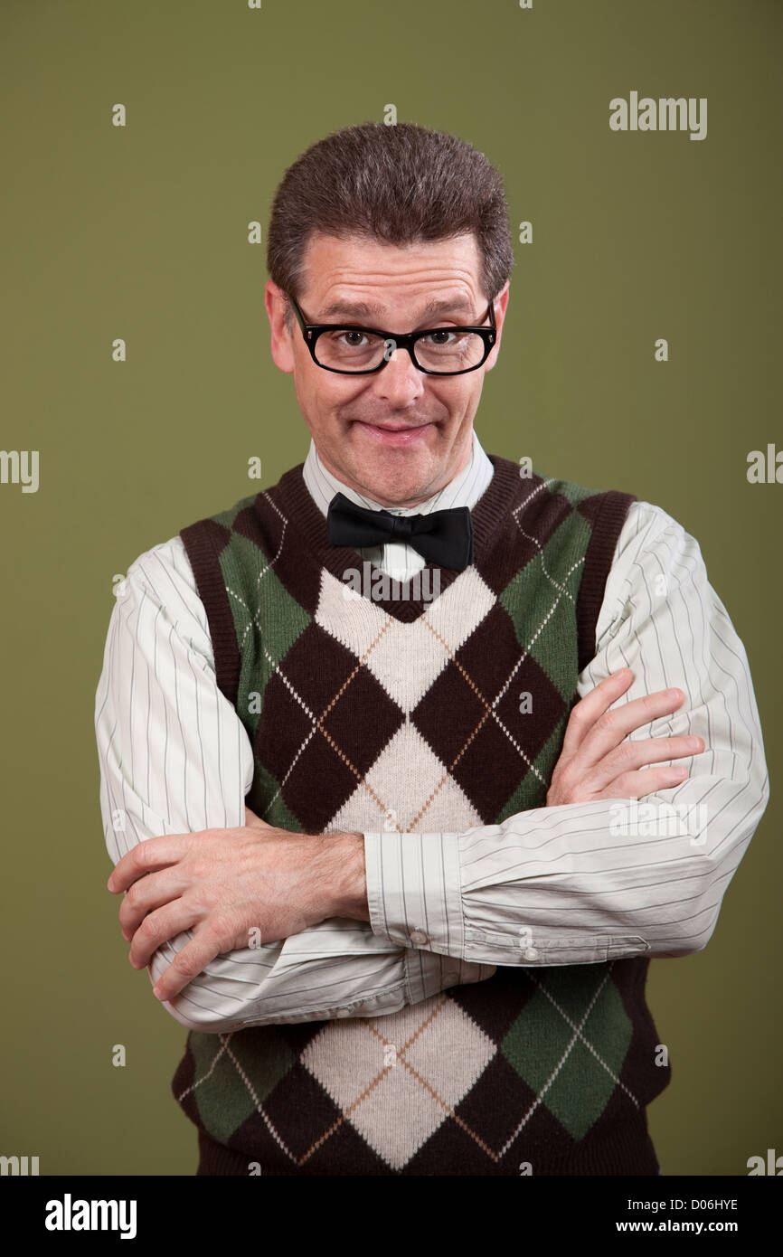 Caucasian nerd with arms folded on green background Stock Photo - Alamy