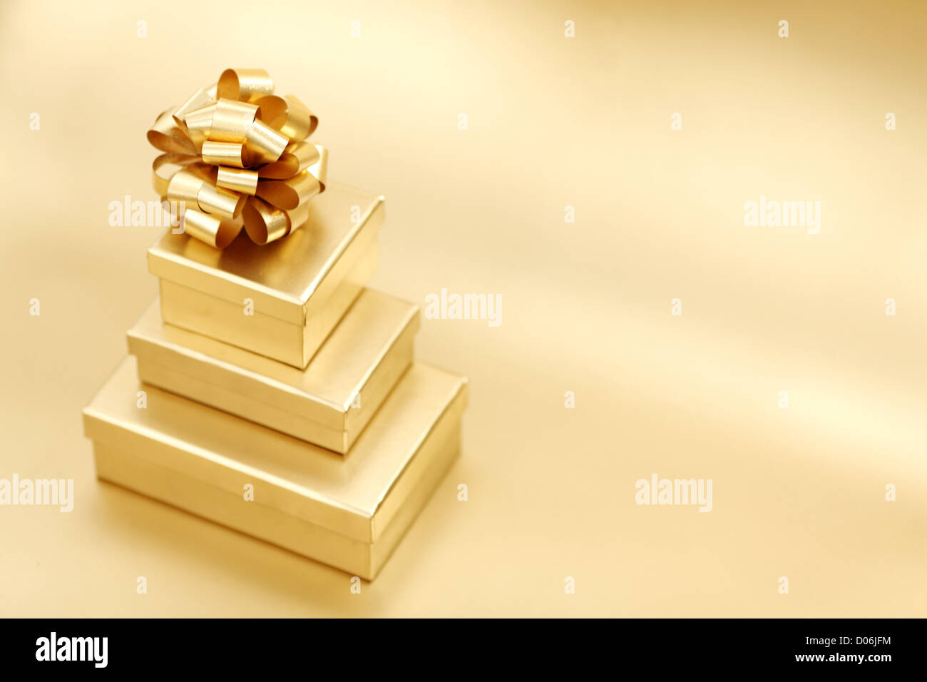 golden christmas gifts on gold background Stock Photo - Alamy