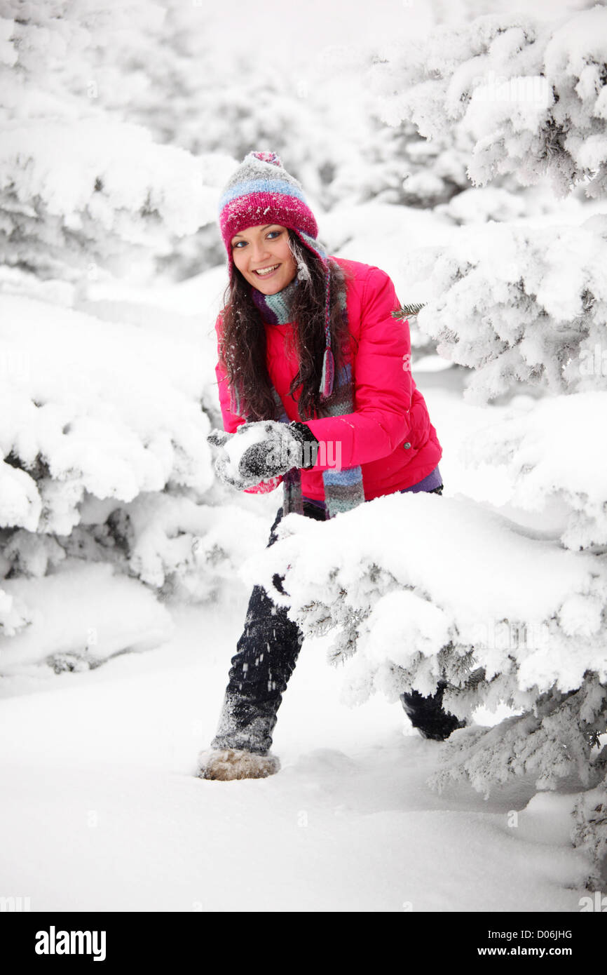 winter woman play snowballs on snow background Stock Photo - Alamy