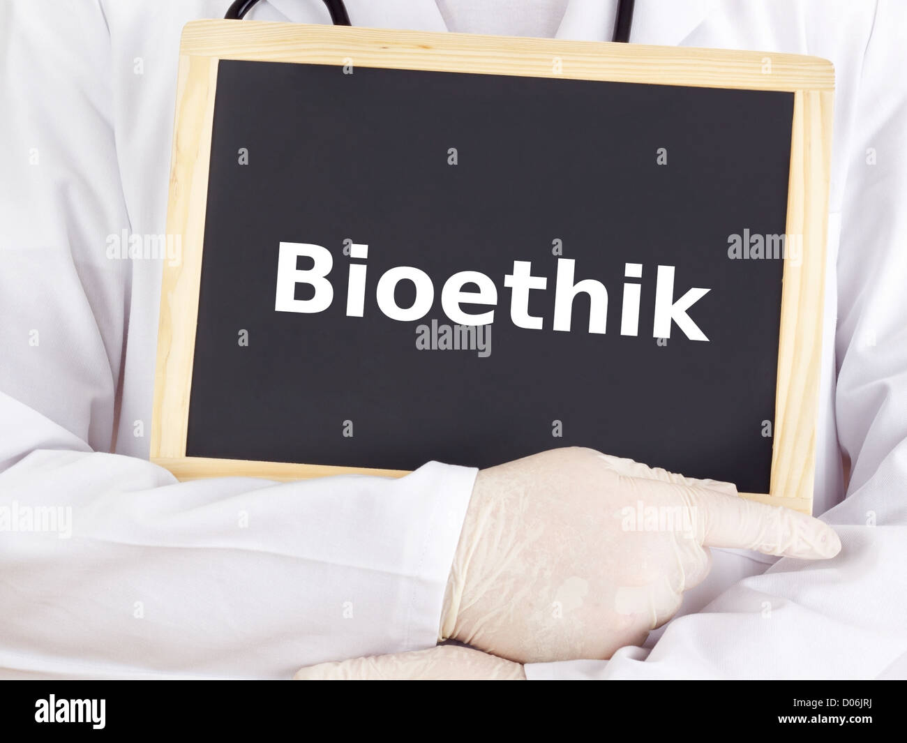 Doctor shows information on blackboard: bioethics Stock Photo - Alamy