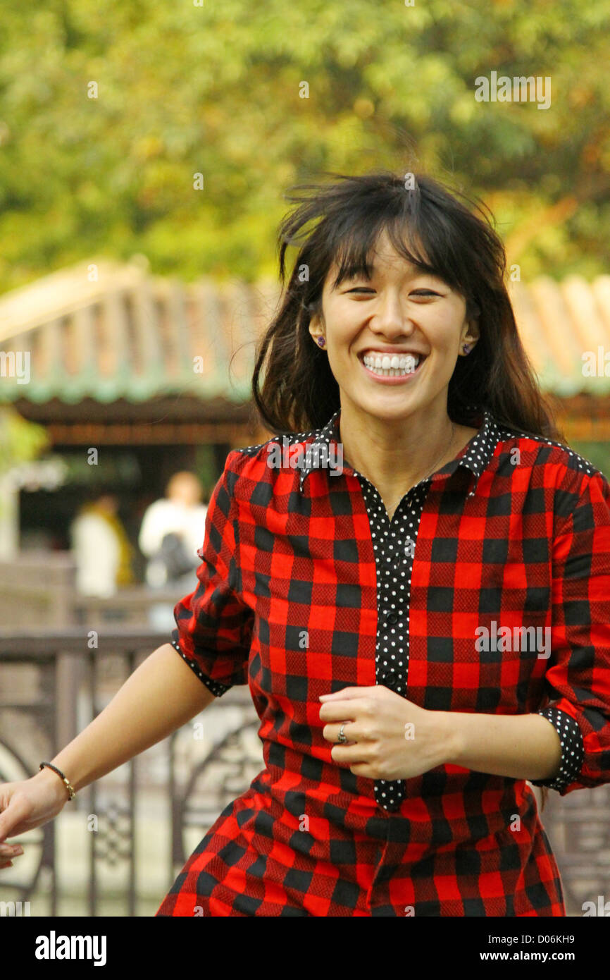 Asian woman running with smile Stock Photo - Alamy