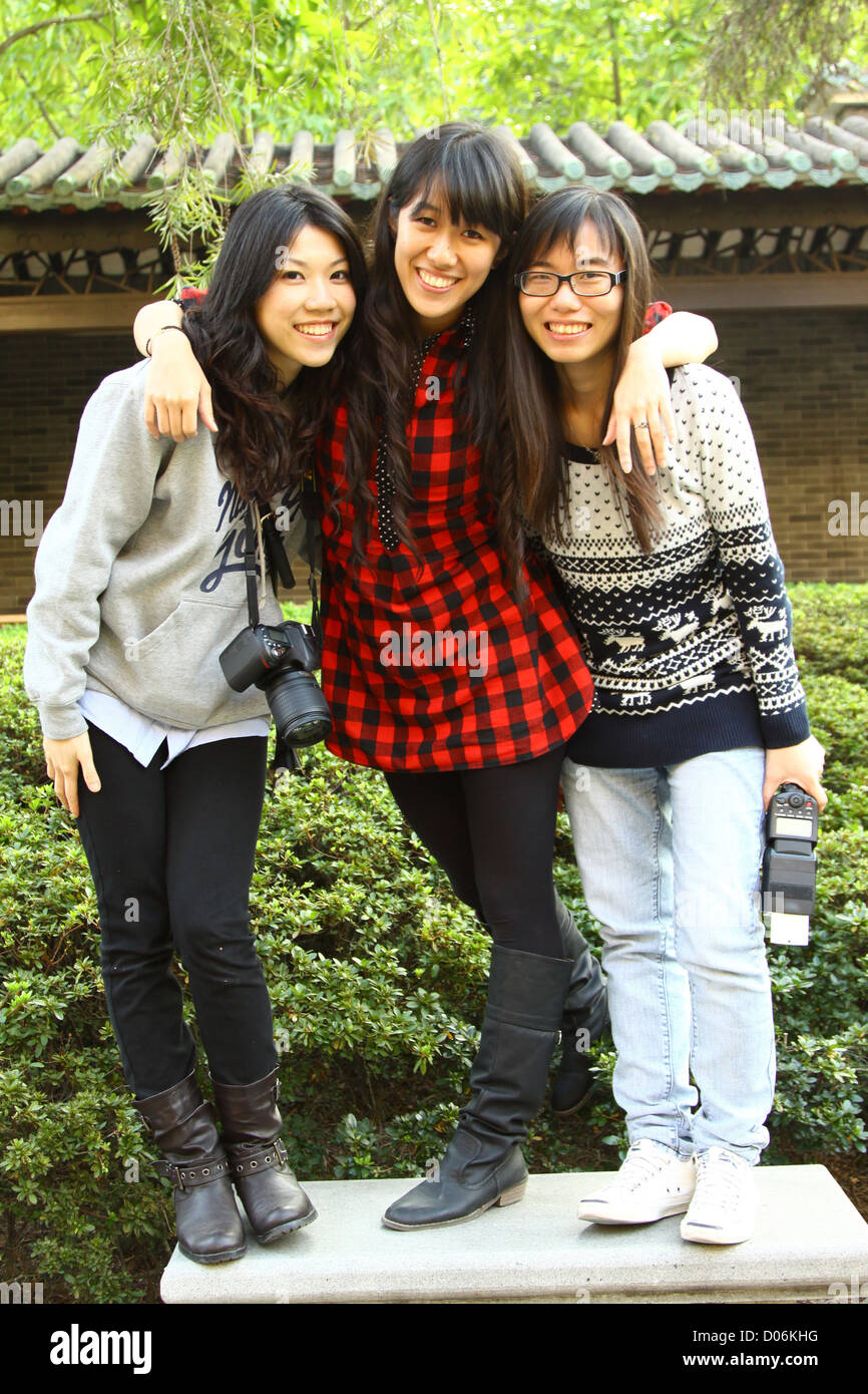 Asian good friends taking photos Stock Photo - Alamy