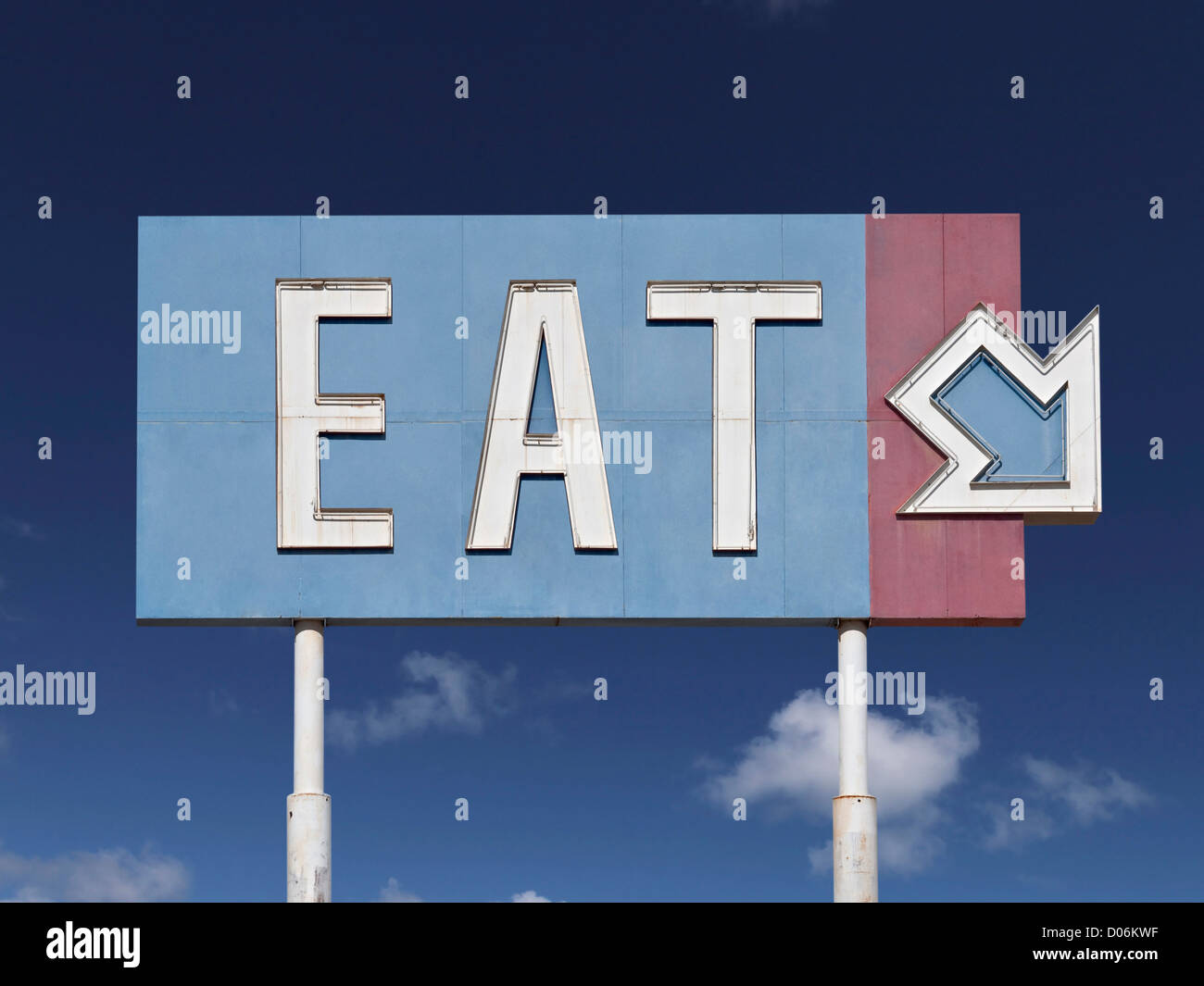 Retro eat arrow sign with blue sky near historic route 66 Stock Photo ...
