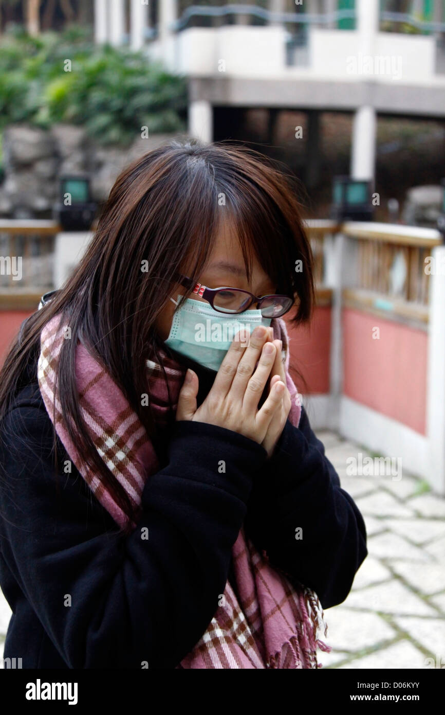 Asian sick girl wearing mask Stock Photo - Alamy