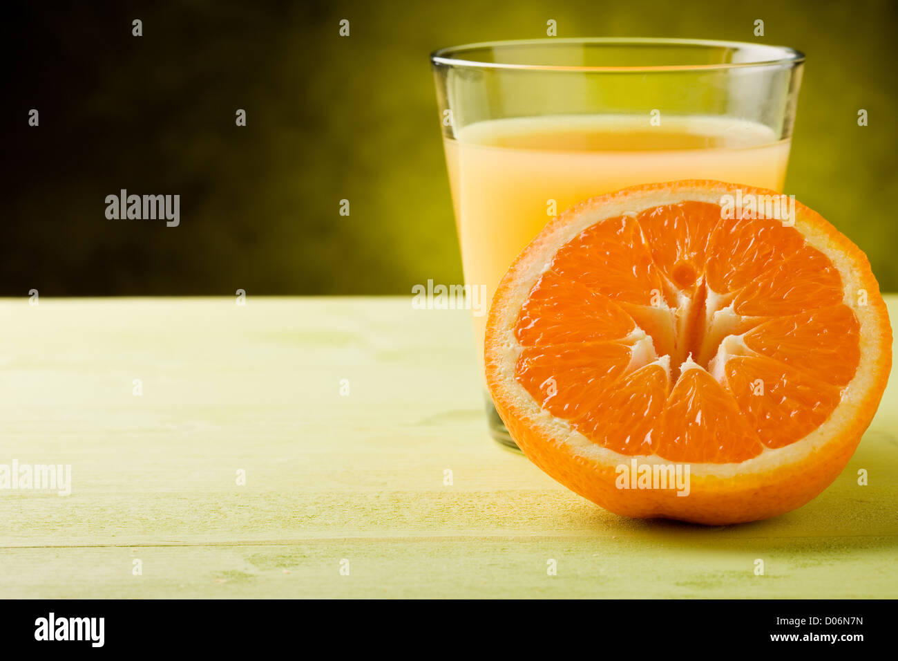 fresh orange juice inside a glass on wooden table Stock Photo - Alamy