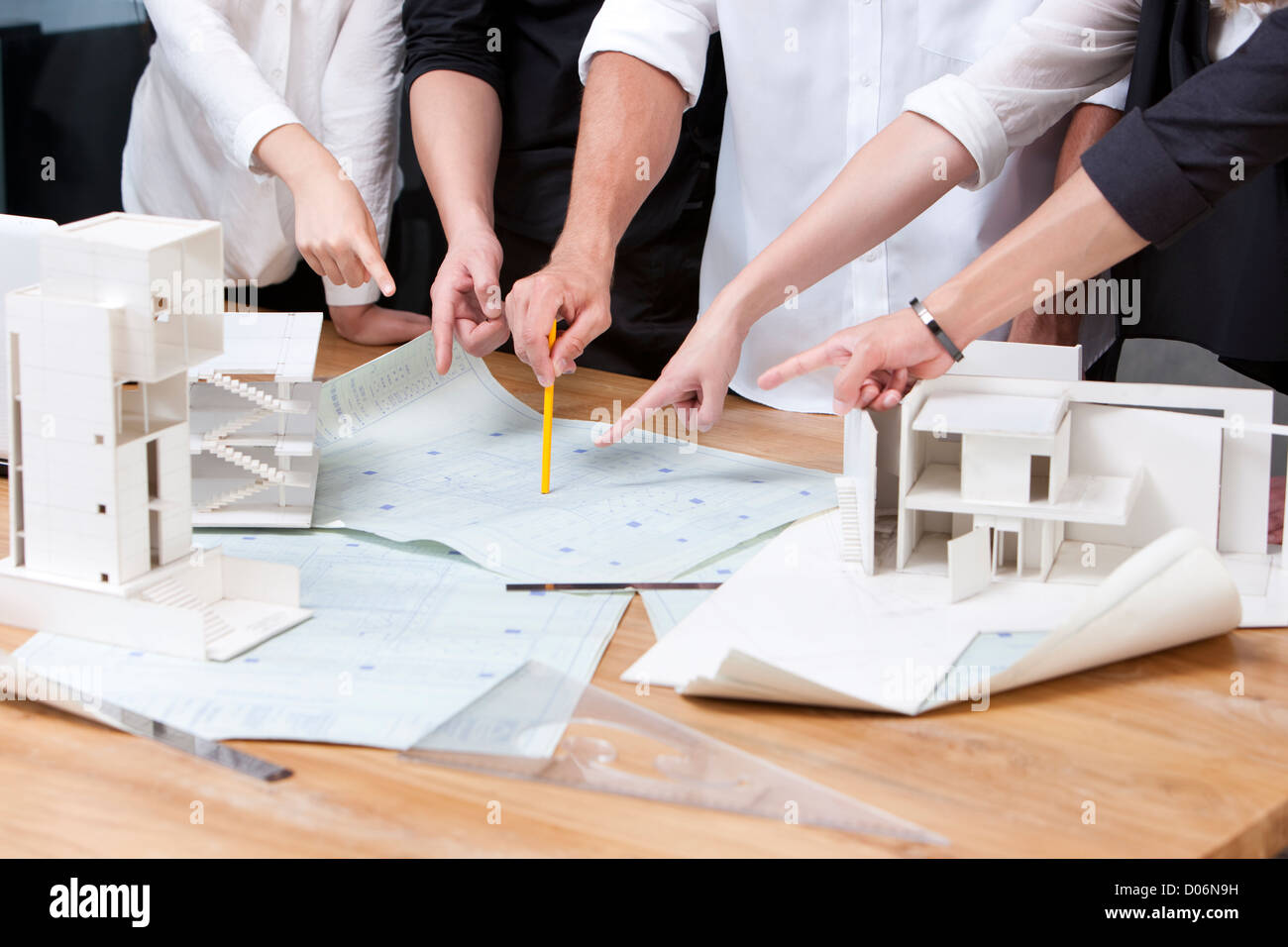 Architects studying the blueprint Stock Photo - Alamy