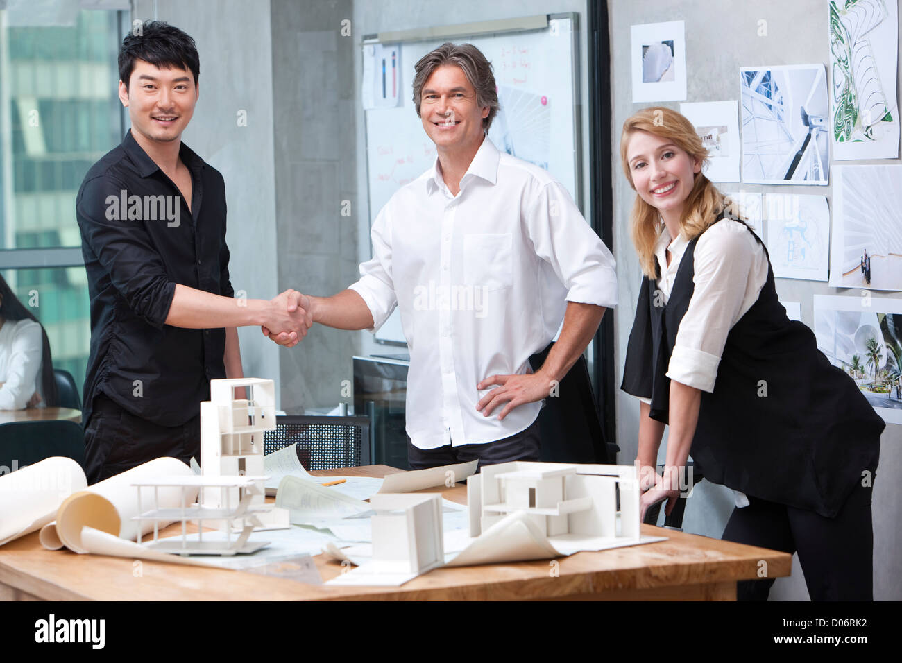 Architects shaking hands in studio Stock Photo - Alamy
