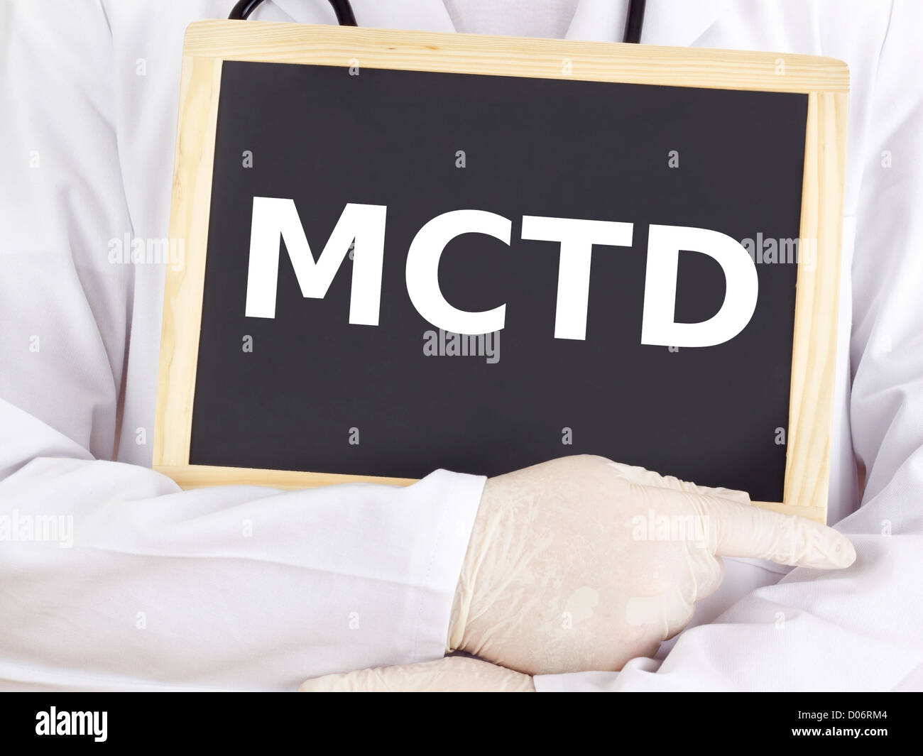 Doctor shows information on blackboard: MCTD Stock Photo - Alamy