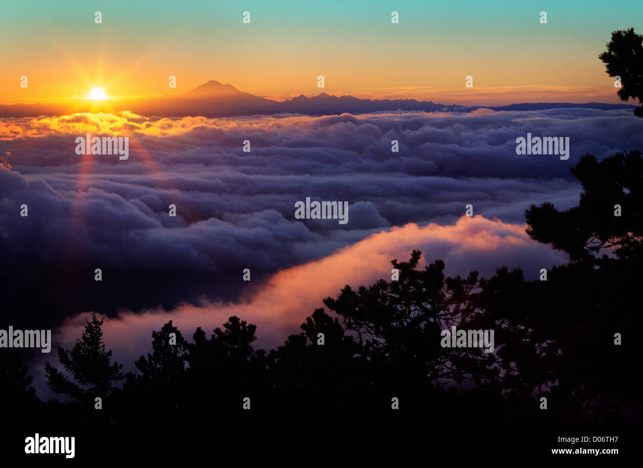 The sun rises behind Mount Baker as seen from the top of Mount ...