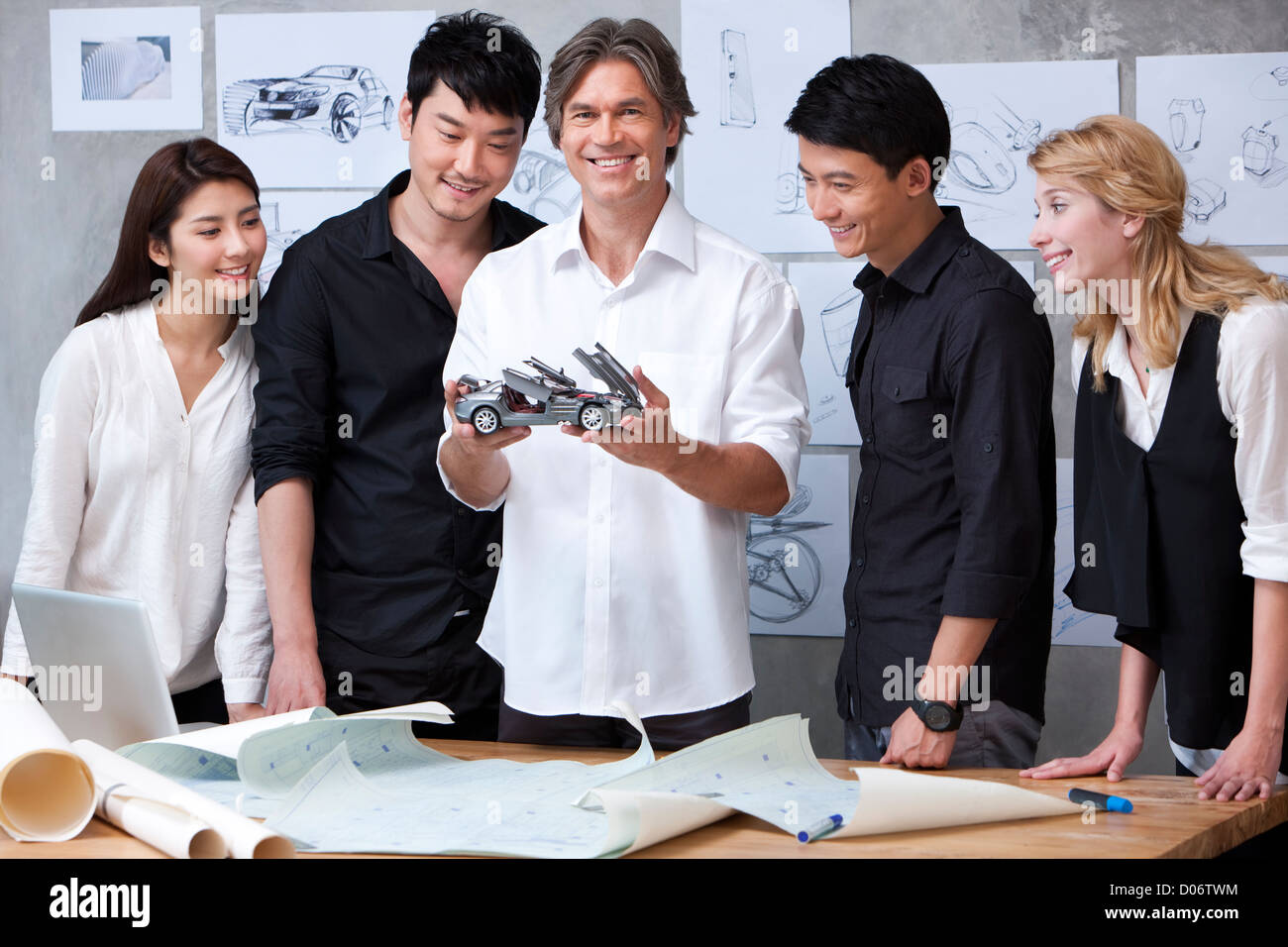 Car designers studying a model car Stock Photo - Alamy