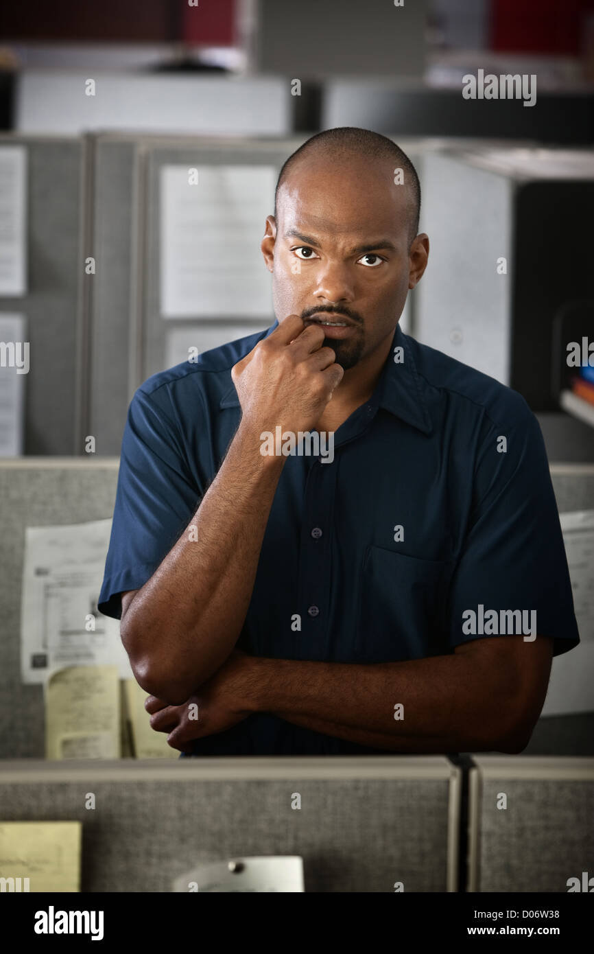 Serious African-American office worker stands in his cubicle Stock ...