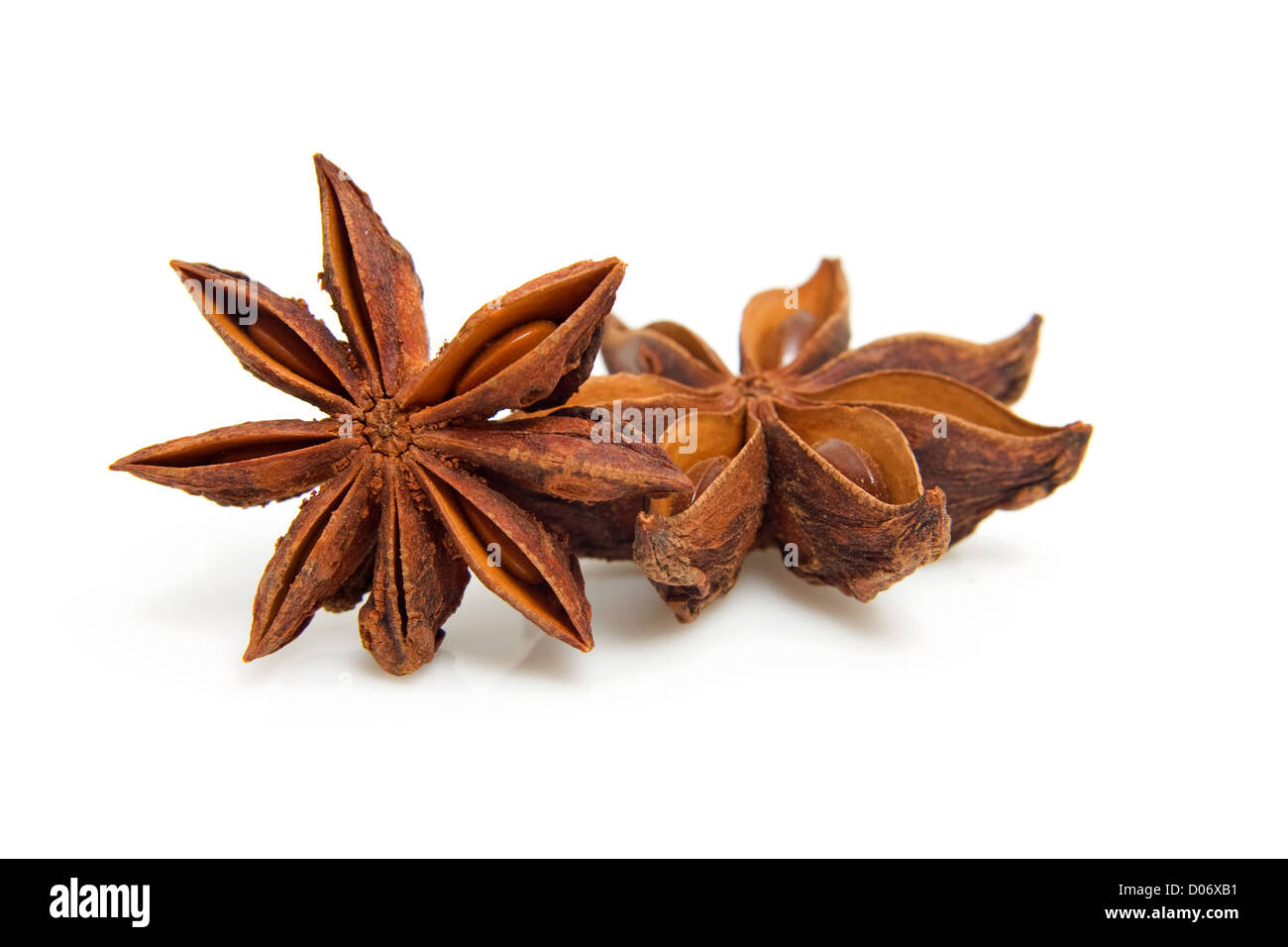 two whole star anise in closeup over white background Stock Photo - Alamy