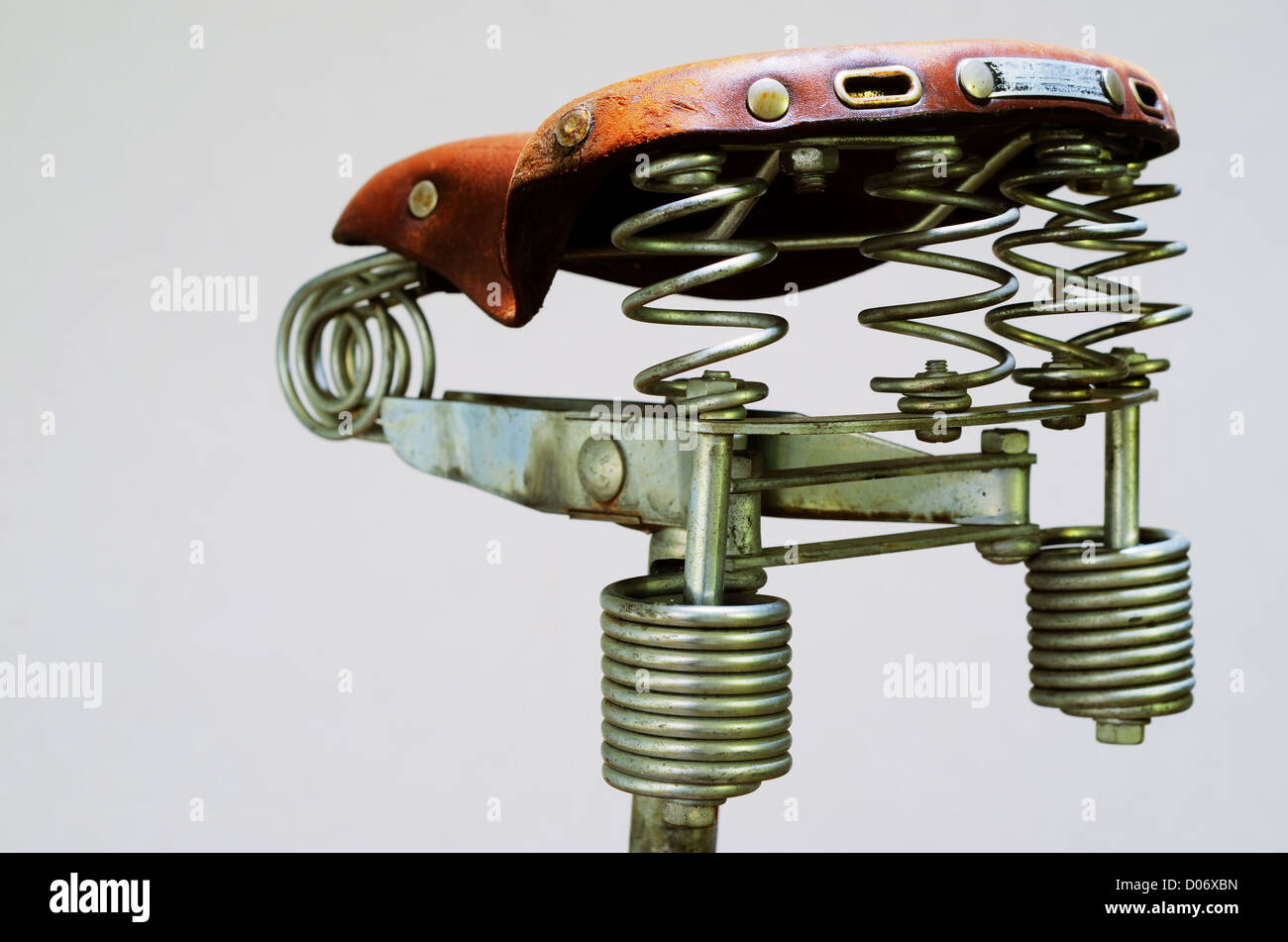 old vintage leather bike saddle with metal spring Stock Photo - Alamy