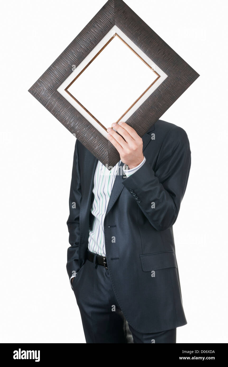 Businessman holding empty frame Stock Photo - Alamy