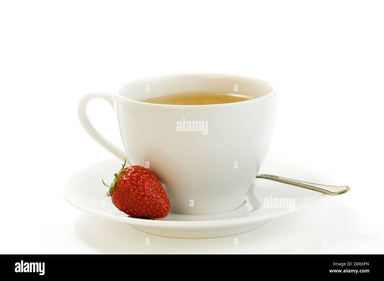 strawberry and white teacup with hot tea on white background Stock ...