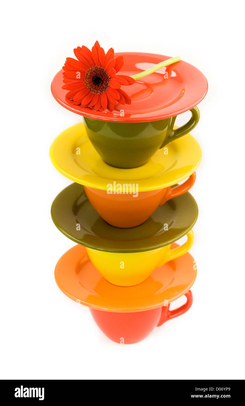 Color cups and red flower on a top. White background Stock Photo - Alamy