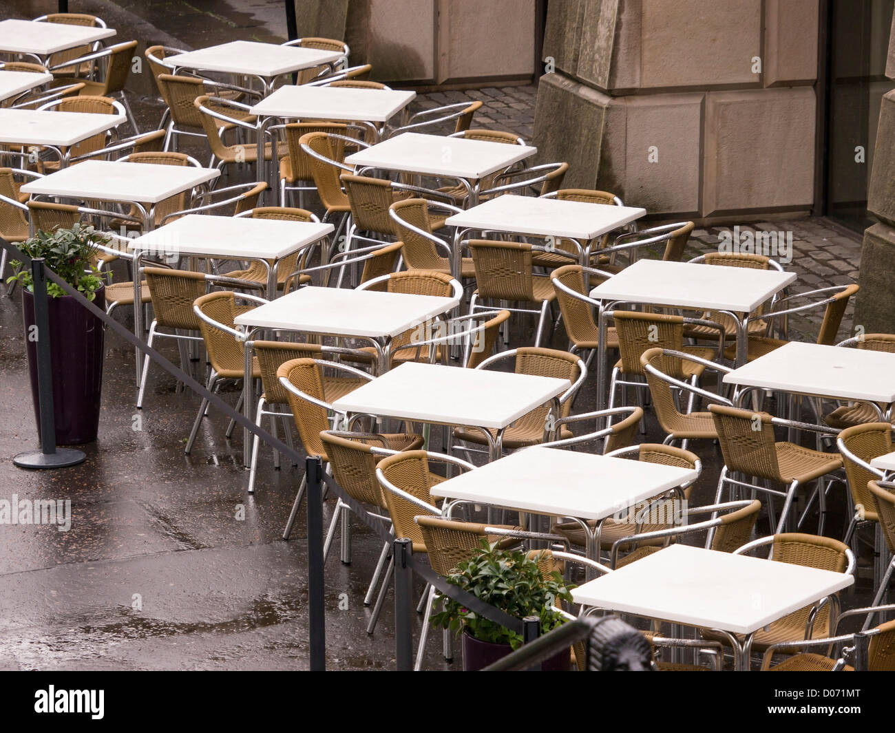 Wet tables and chairs outside a cafe in the rain, in Edinburgh ...