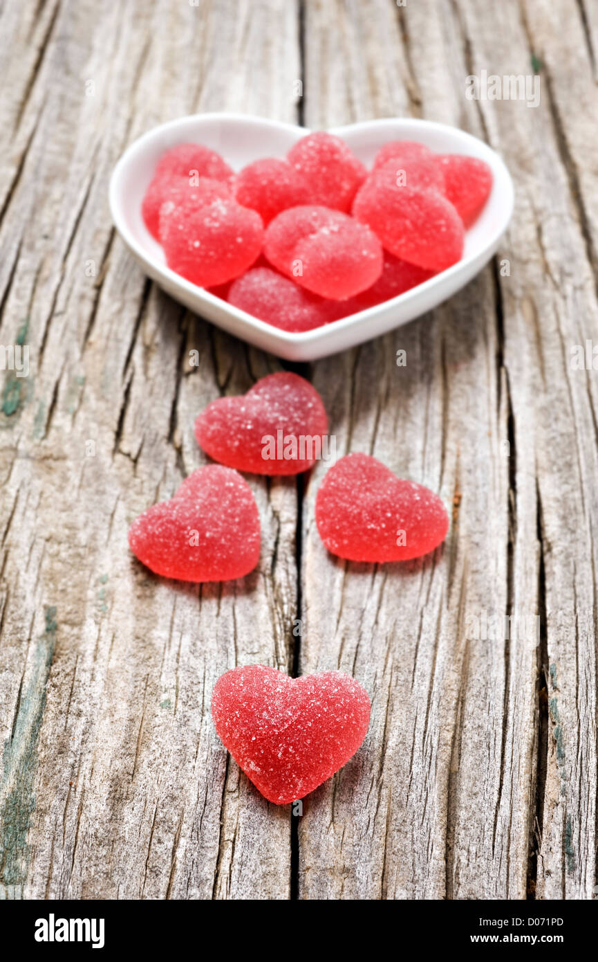 Red heart shaped jelly sweets on a rustic background Stock Photo - Alamy