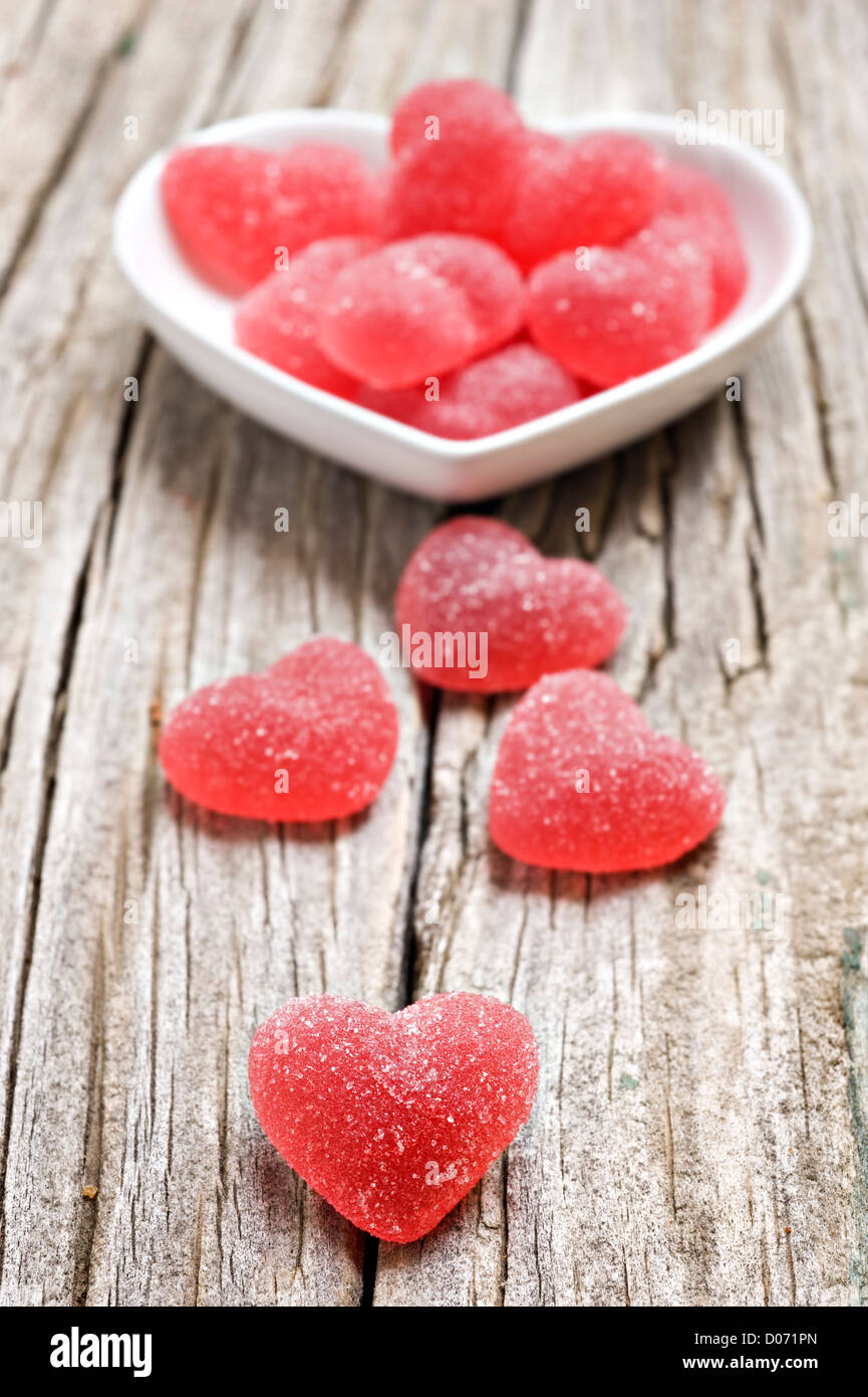 Red heart shaped jelly sweets on a rustic background Stock Photo - Alamy
