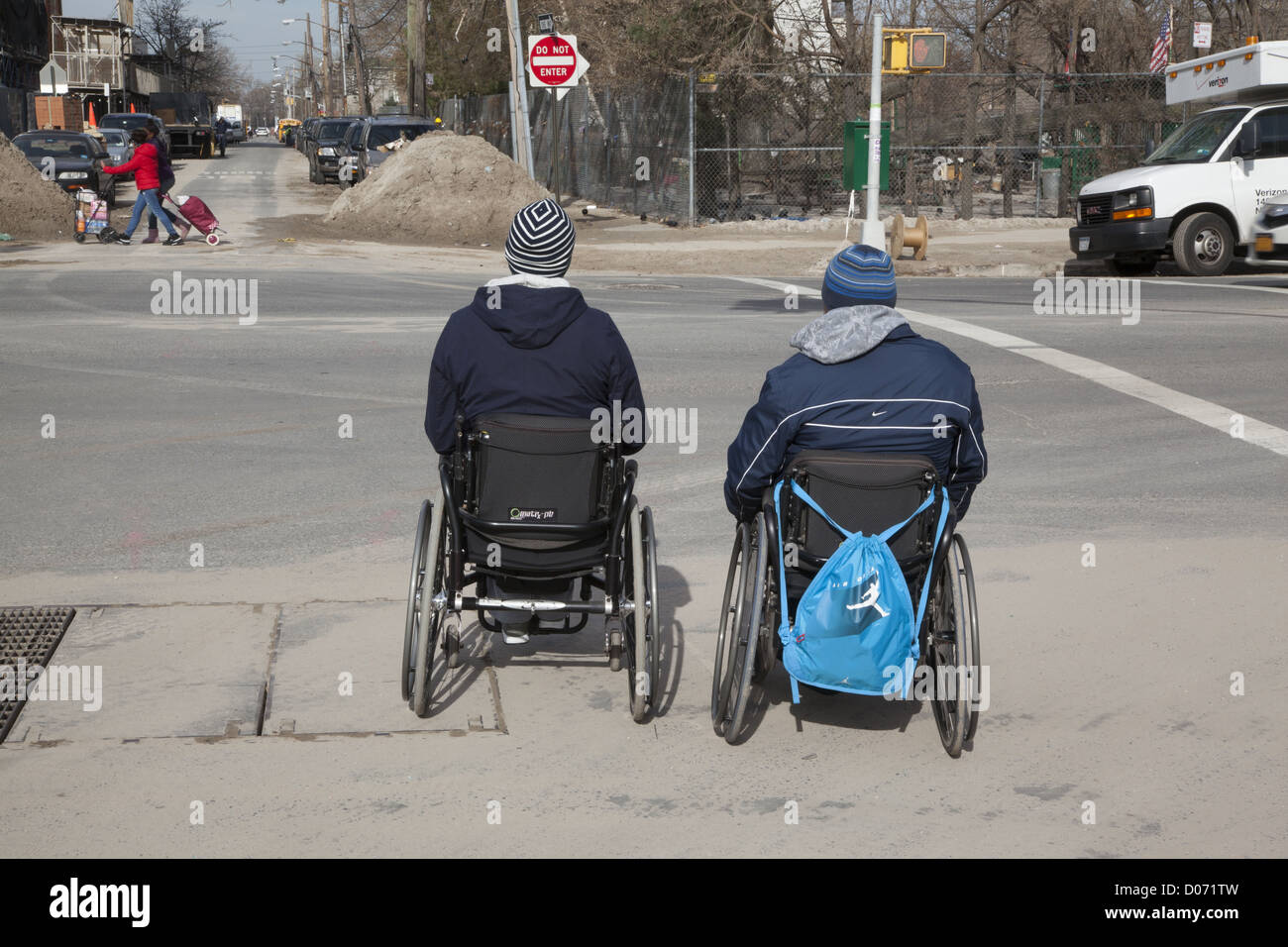 Two wheelchair bound residents wait to cross the street in Coney Island ...