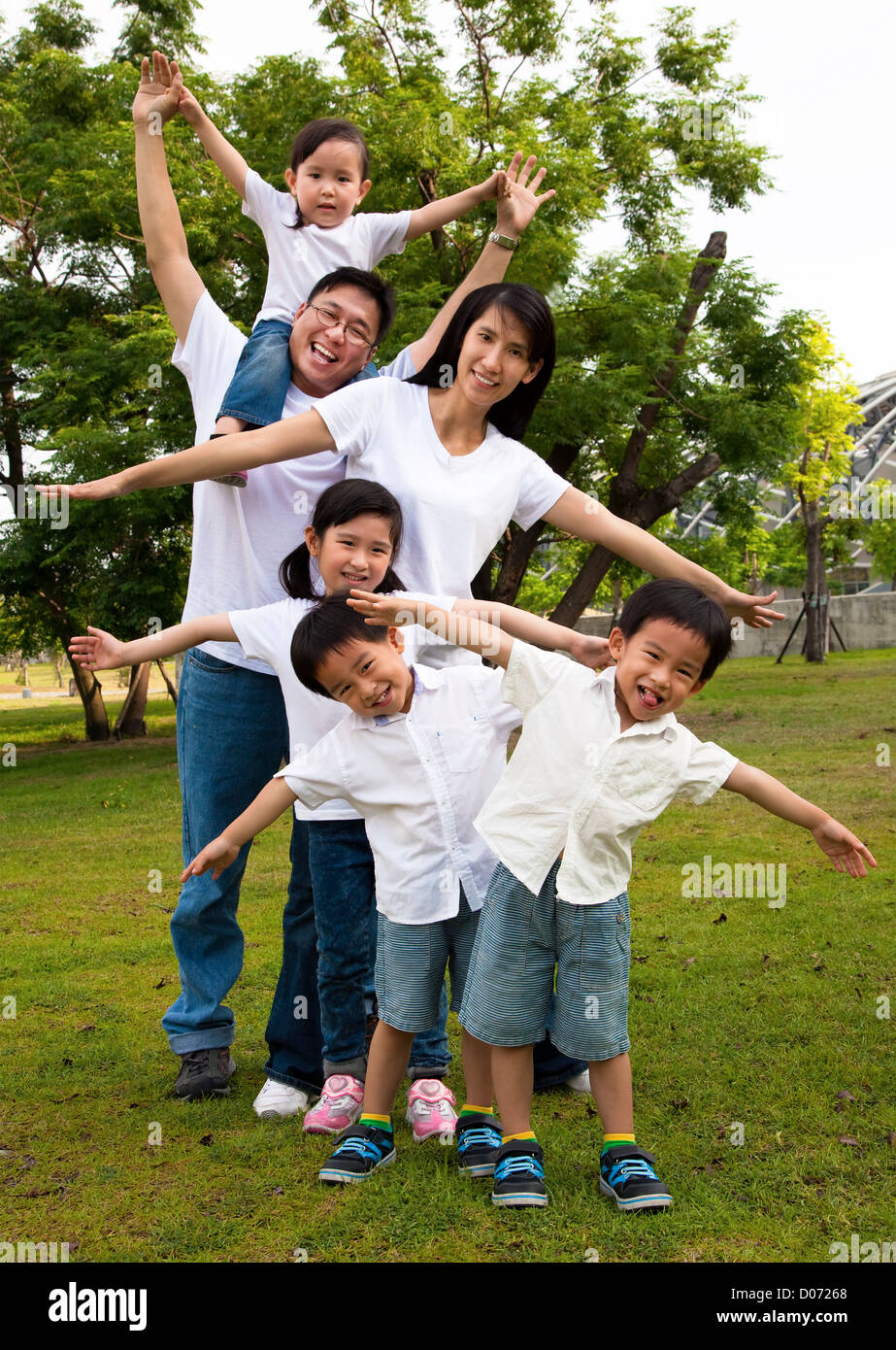 Happy asian family in the park Stock Photo - Alamy
