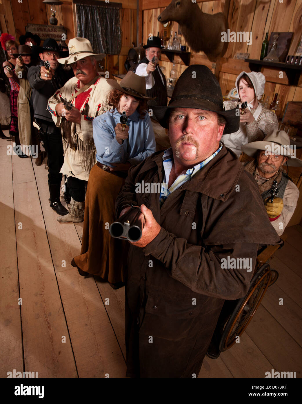 The entire saloon points their guns at an unseen danger Stock Photo - Alamy