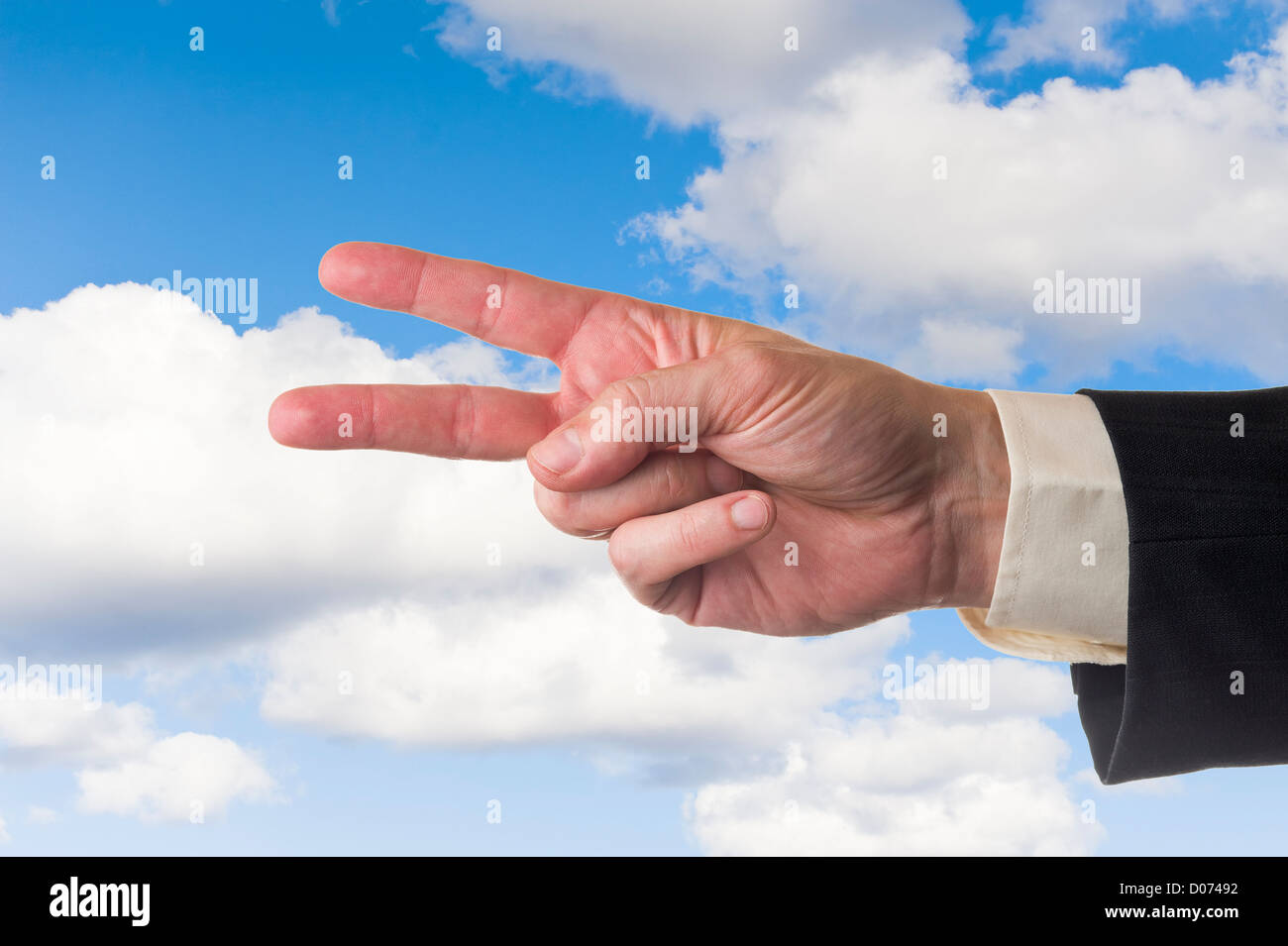 Mans hand, showing two fingers, cloudy blue sky background Stock Photo ...