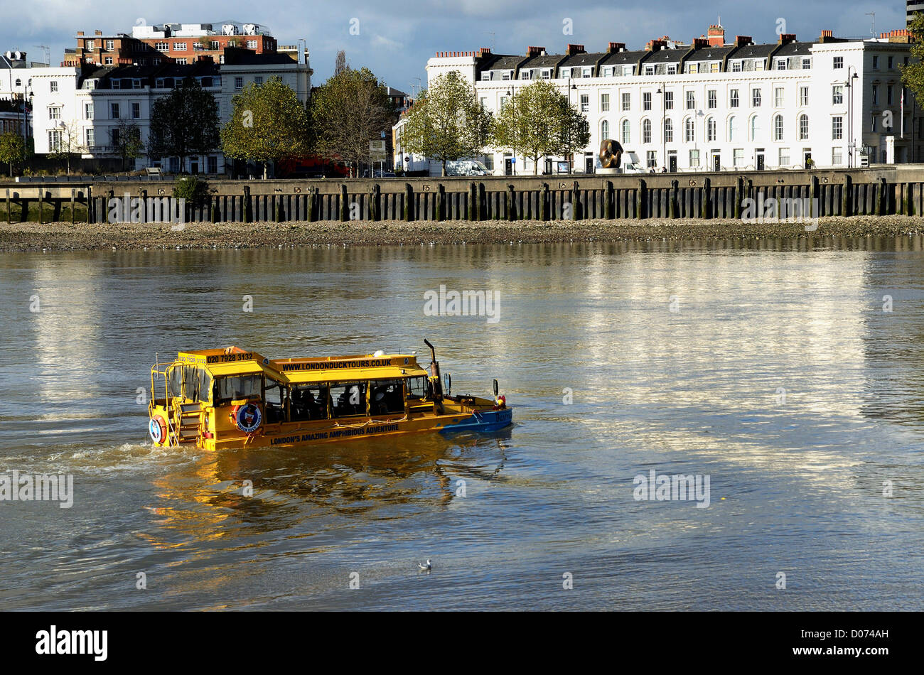 Yellow amphibious tourist vehicle on the River Thames at Millbank ...