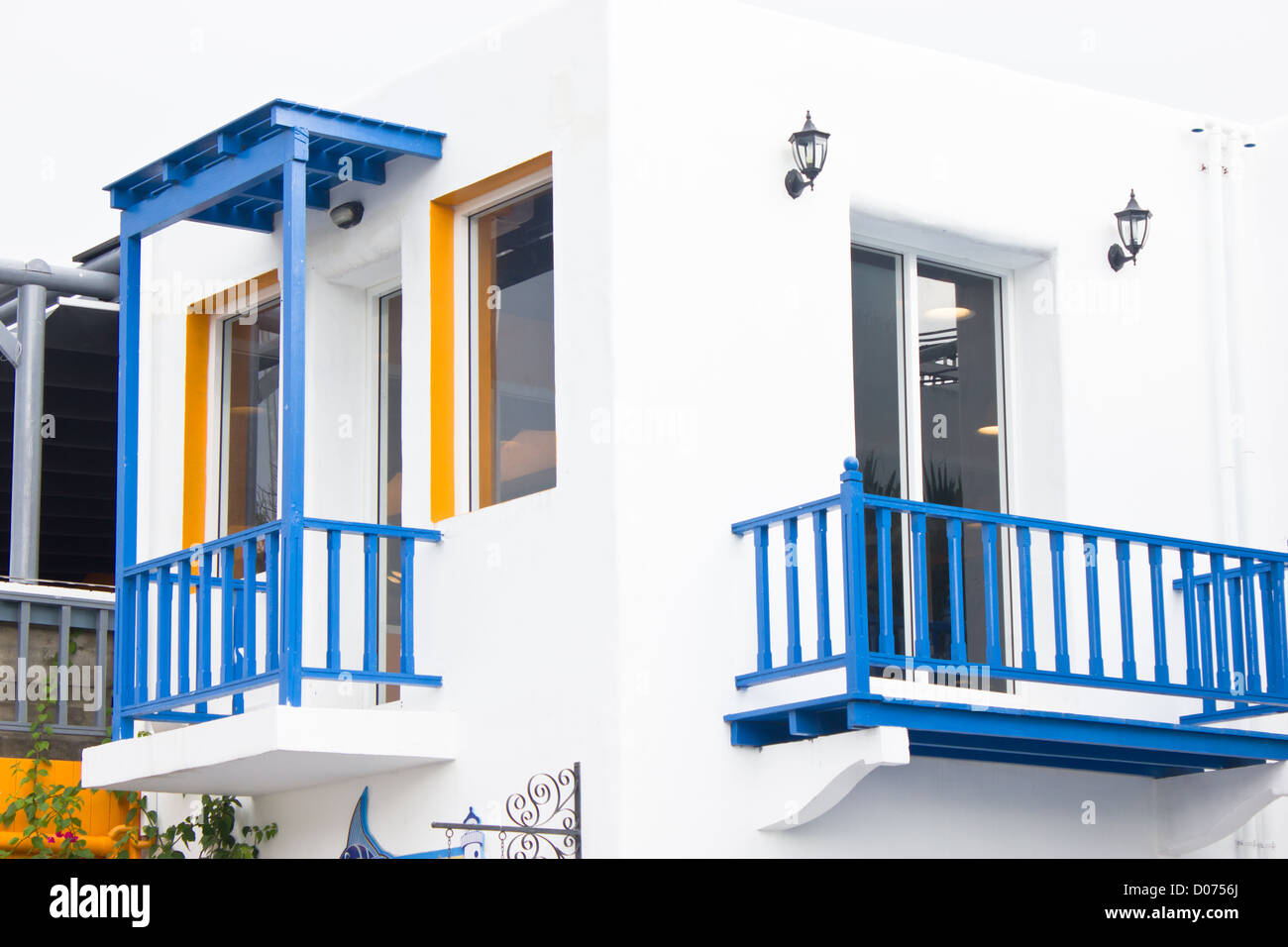 White building with blue balcony mediterranean style Stock Photo - Alamy