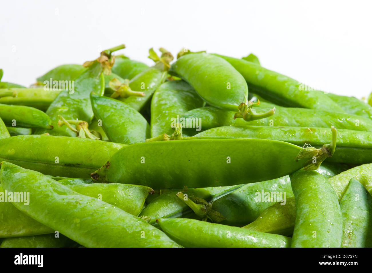 Many green beans on pile, white background Stock Photo - Alamy