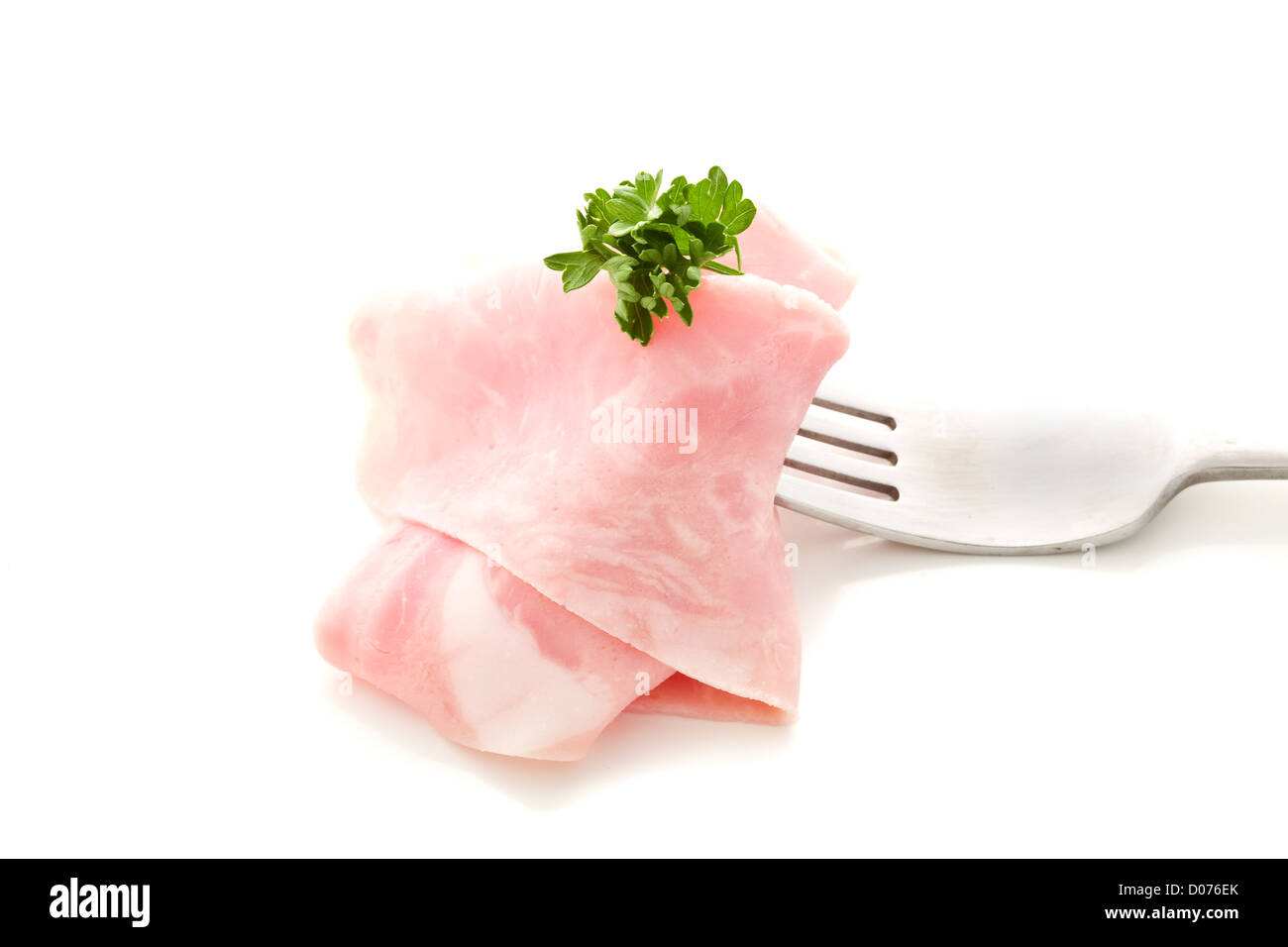 photo of delicious ham sliced wrapped on fork over white background ...