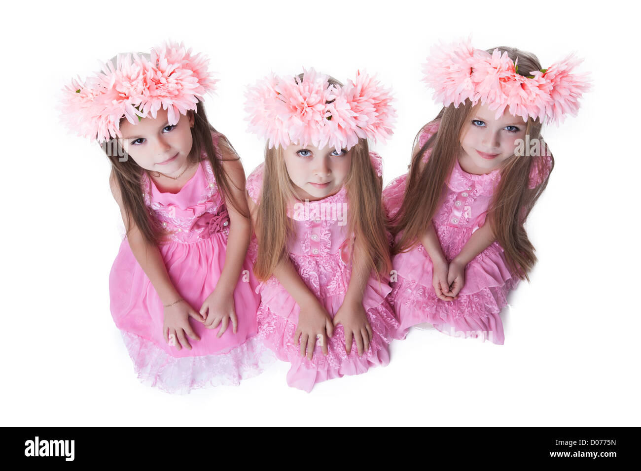 Three beautiful little girls with pink wreaths. Isolated on white Stock ...