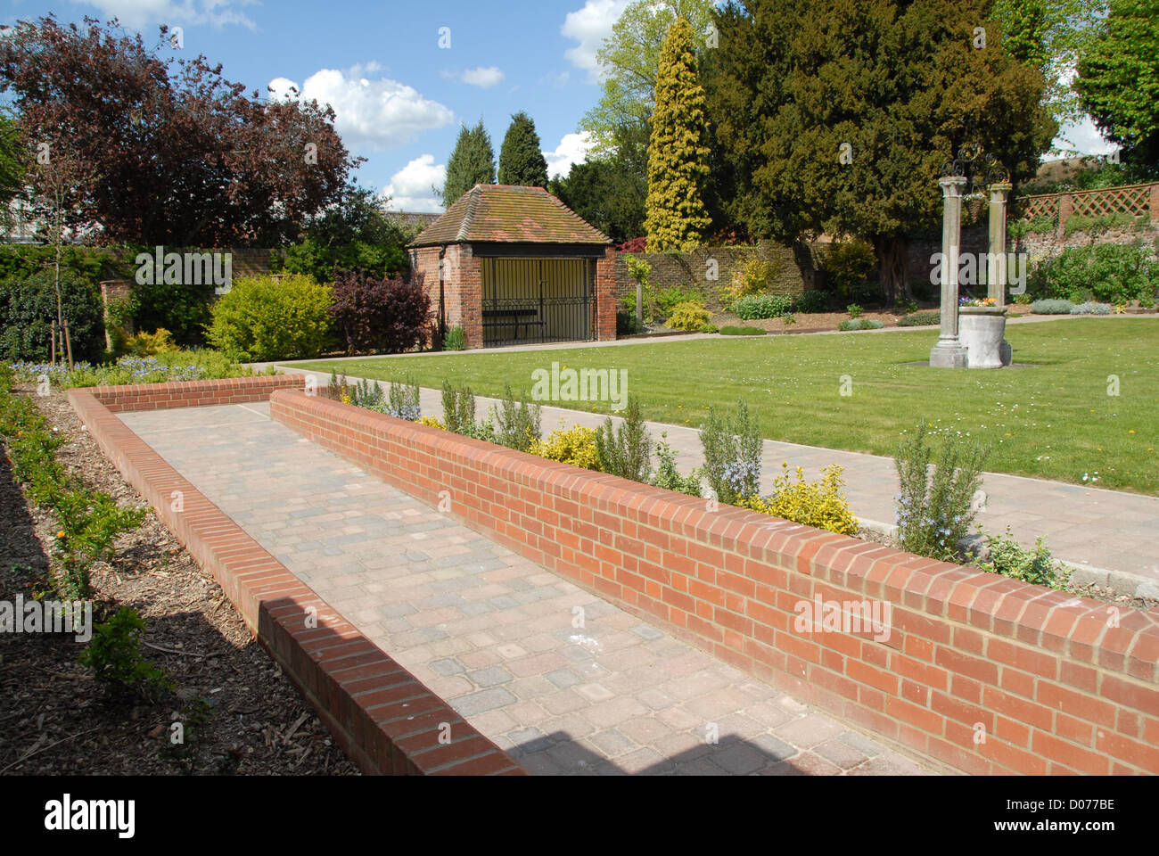 Disabled slope into gardens with brick wall Stock Photo - Alamy