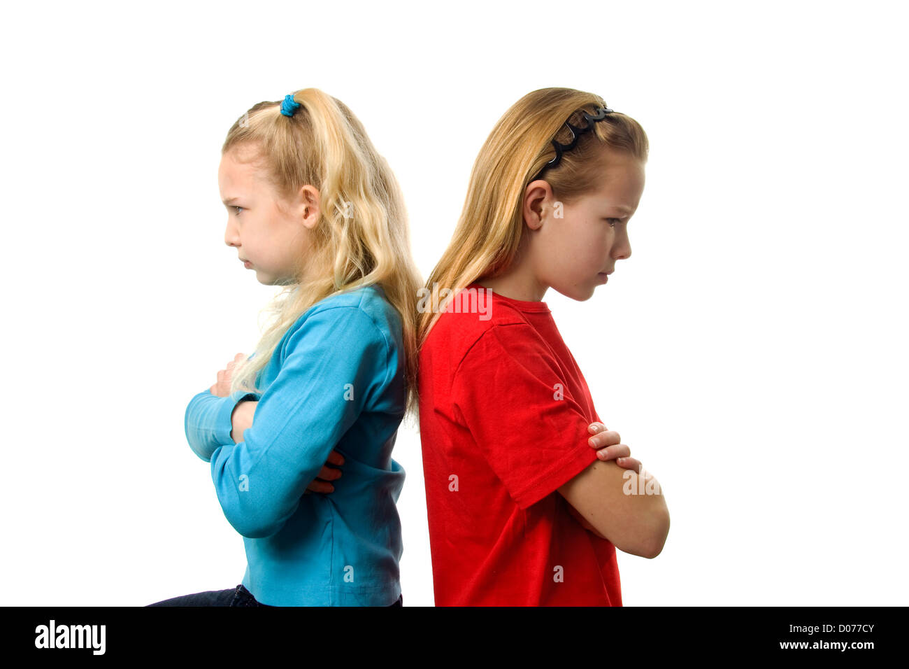 Two young blonde girls are angry at each other over white background ...